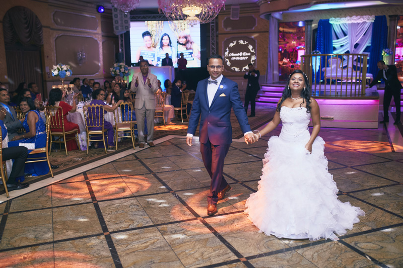 bride and groom holding hands